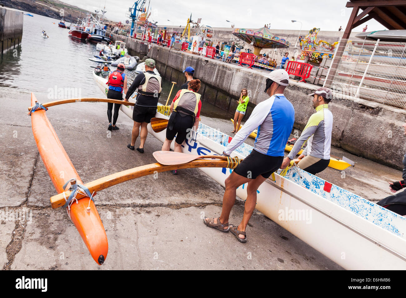 Six man rowing team launching an outrigger canoe at Playa San Juan ...