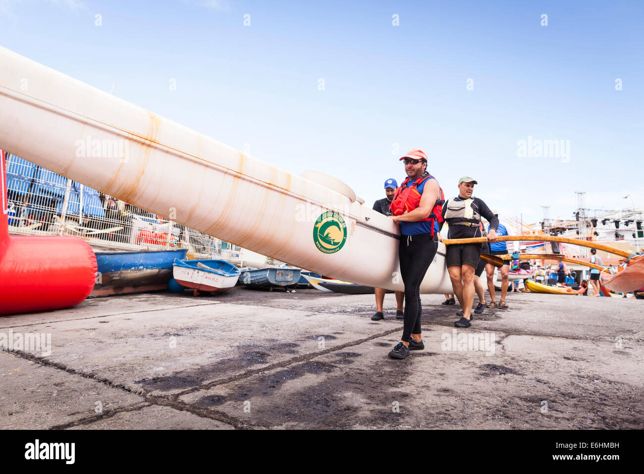 Six man rowing team launching an outrigger canoe at Playa San Juan ...