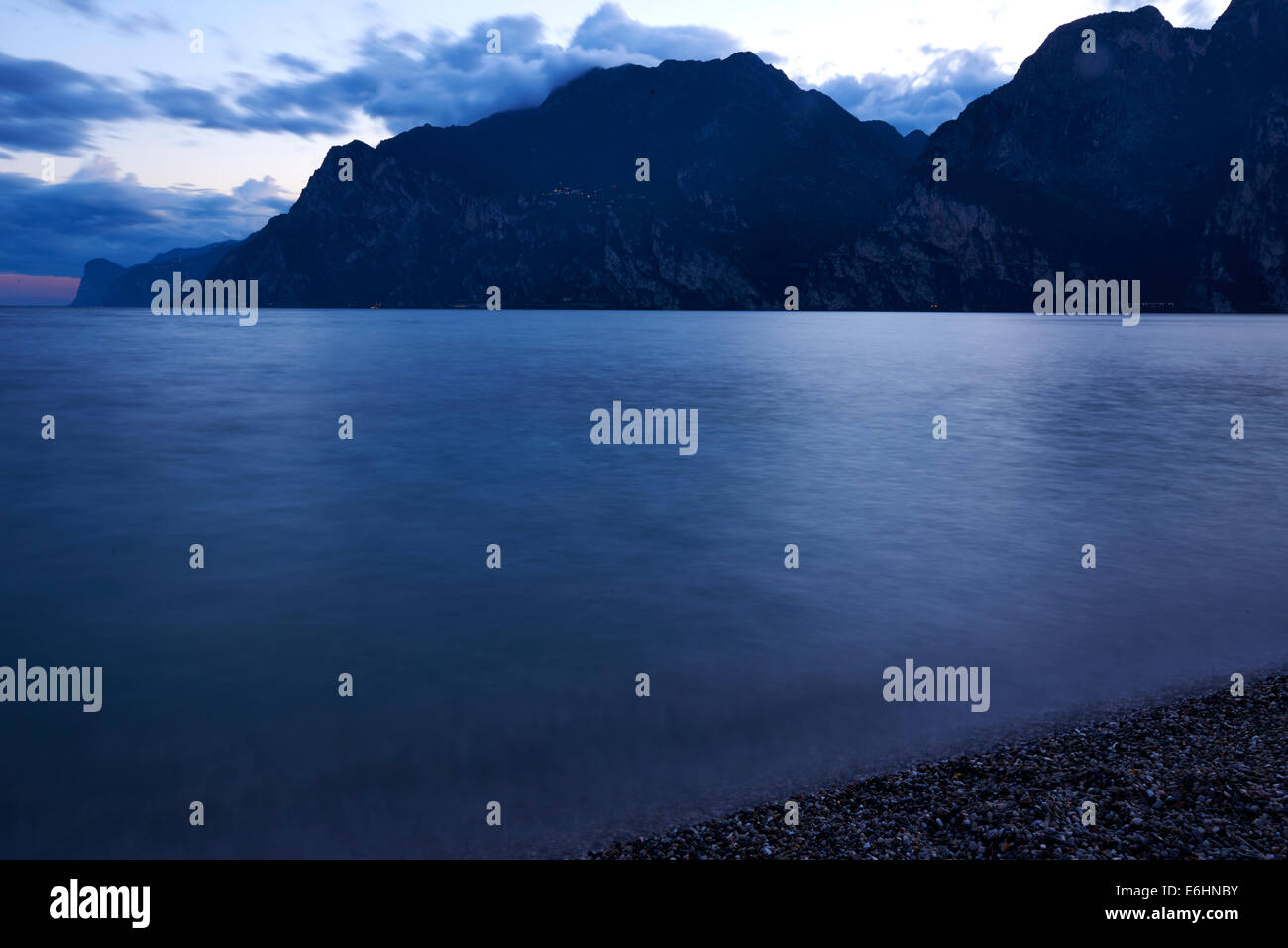 Lago di Garda pebble beach at dusk, Torbole, Lake Garda, Italian Lakes ...
