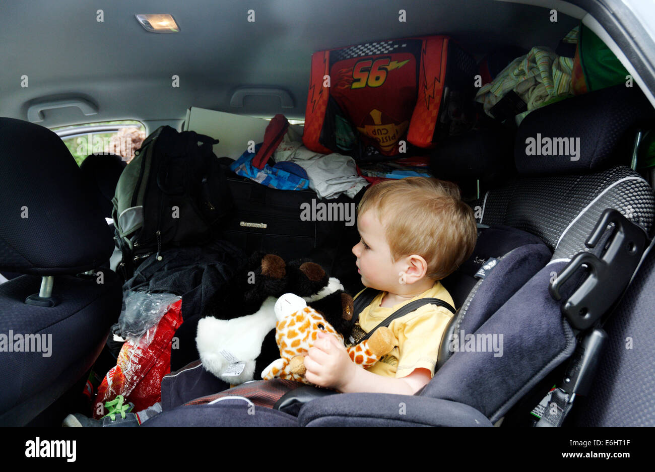 A young boy in a very full car on the day we moved house Stock Photo ...