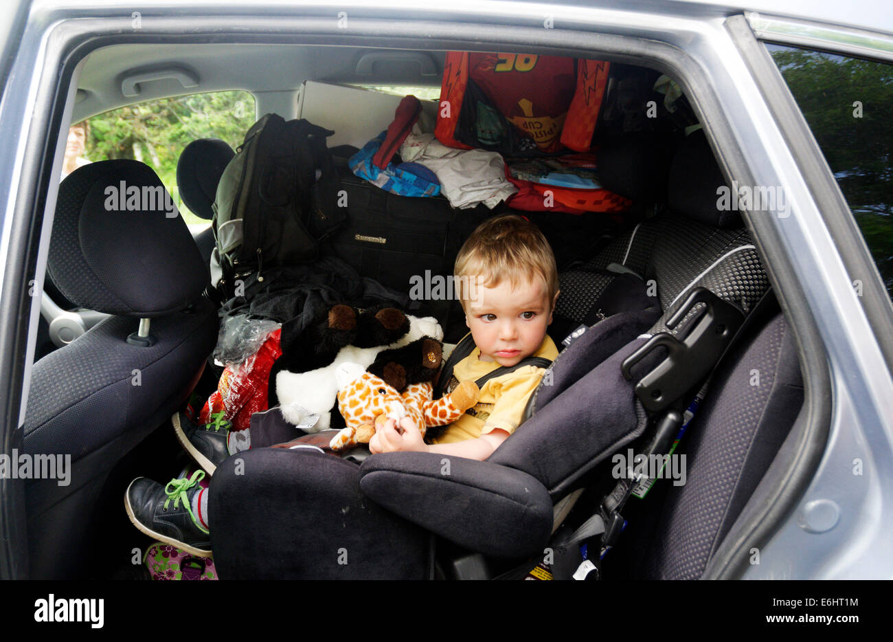 A young boy in a very full car on the day we moved house Stock Photo ...