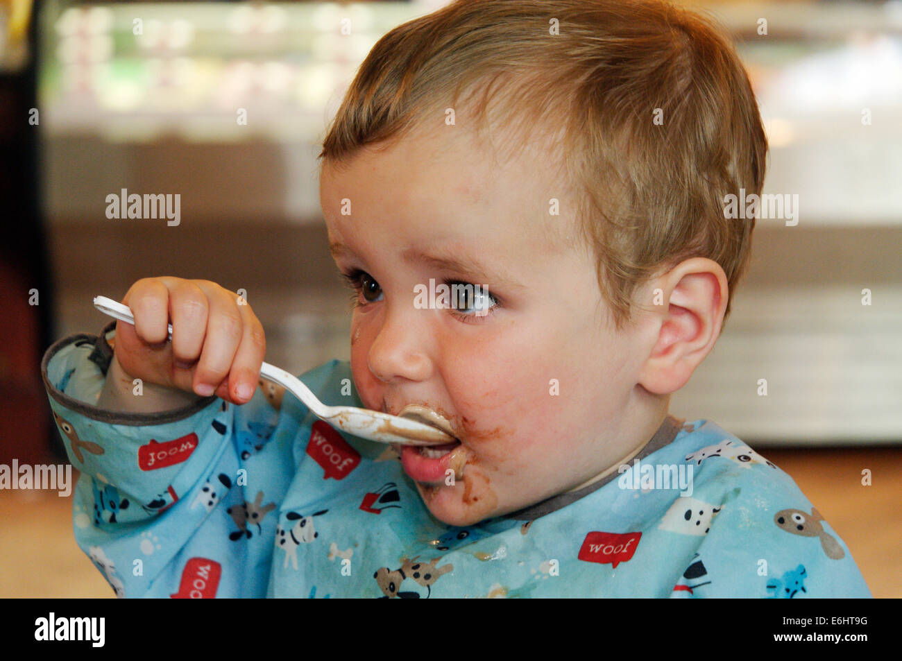 A two year old with chocolate sauce all over his face Stock Photo - Alamy