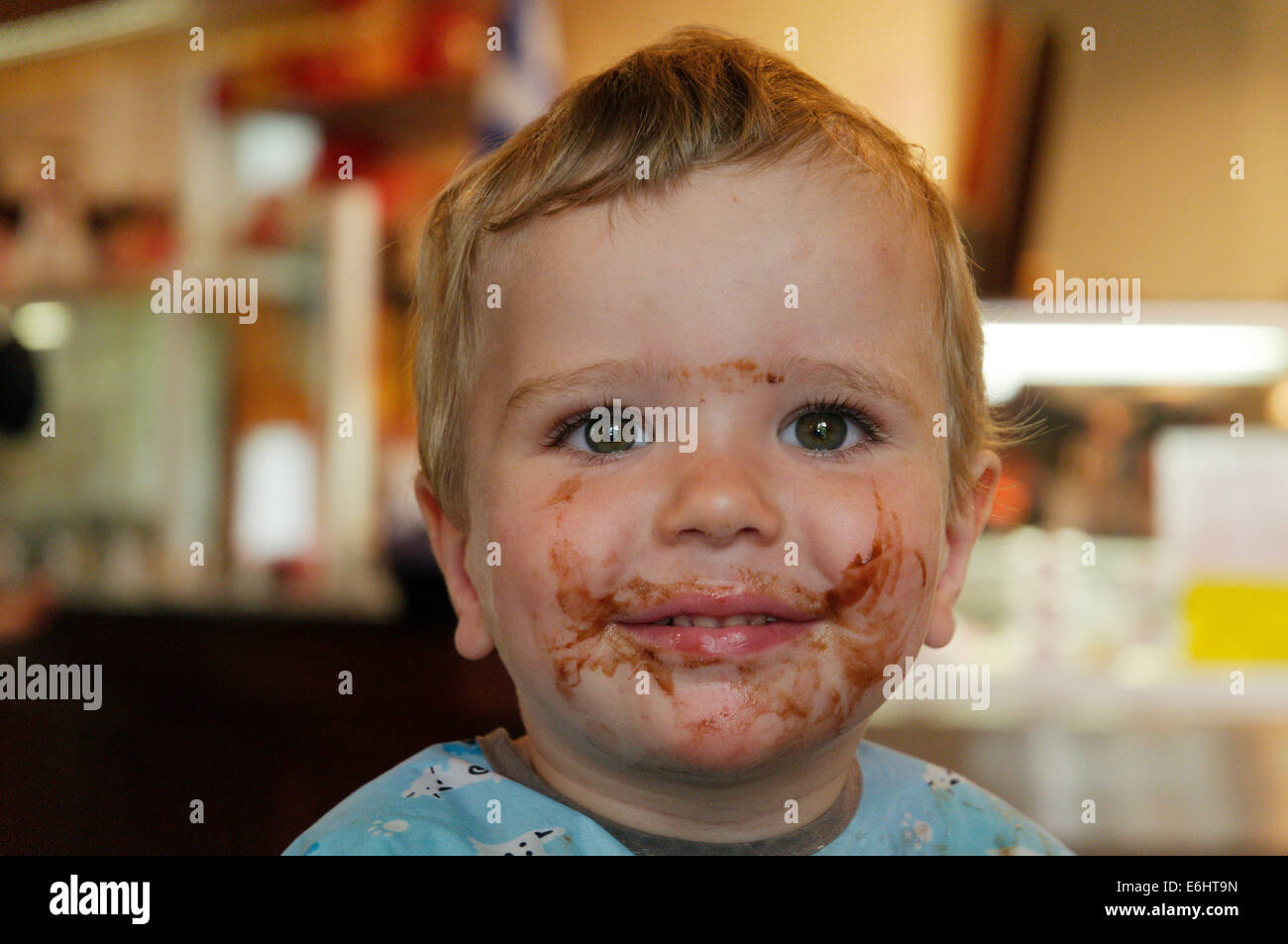A two year old with chocolate sauce all over his face Stock Photo - Alamy