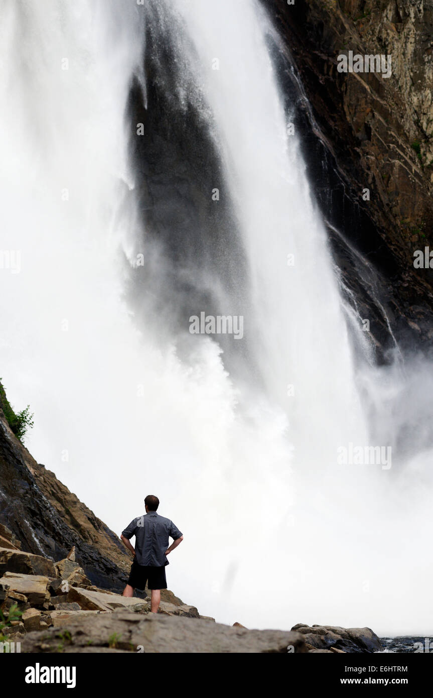 A man looking at Chute Montmorency waterfall near Quebec City, Canada ...