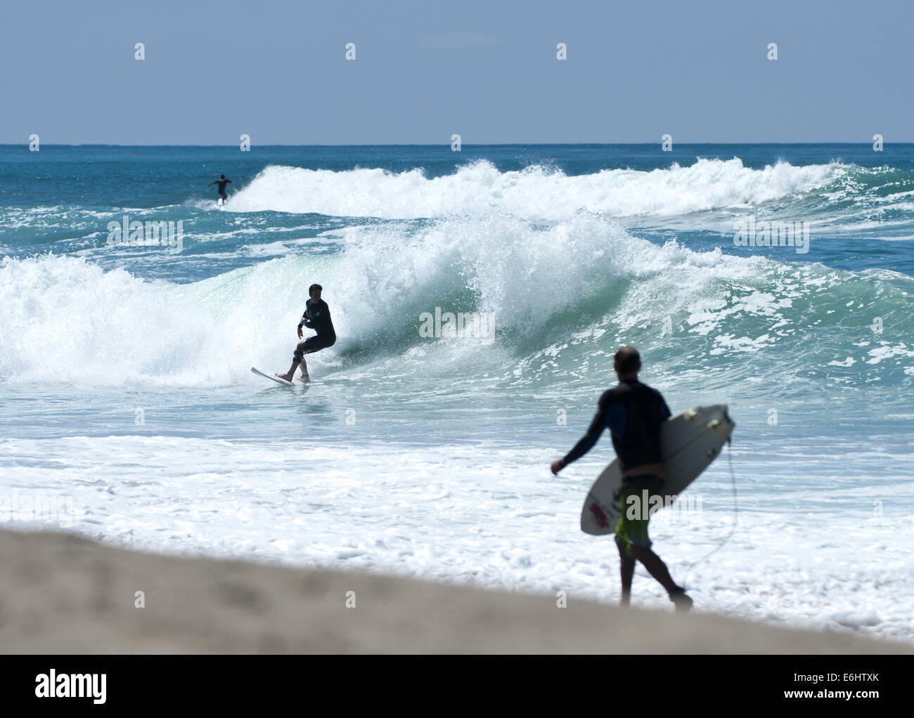 Young surfer coming out of the water on the beach hi-res stock ...
