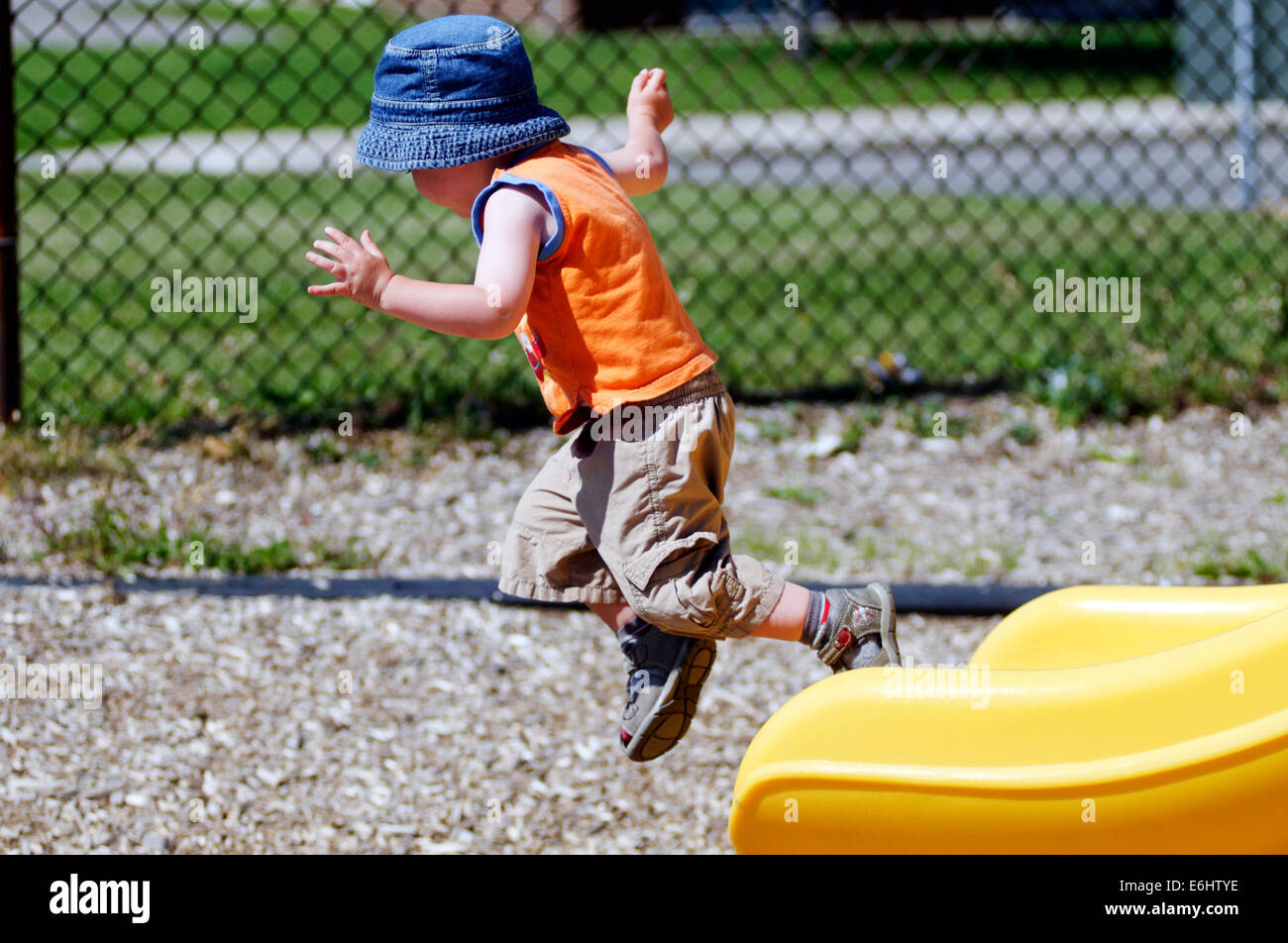 A two year old boy jumping from a slide Stock Photo - Alamy