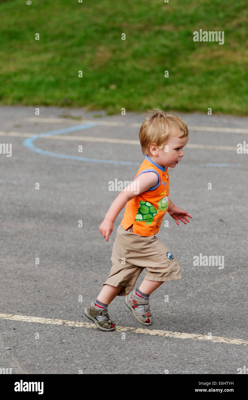 A happy young boy running at full speed Stock Photo - Alamy
