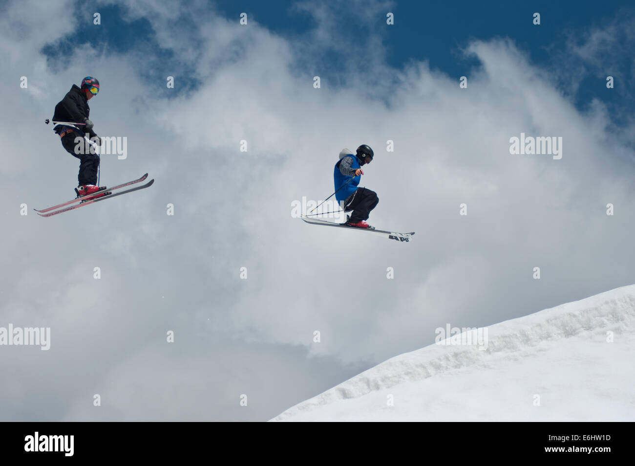 Snow and ski riders jump in the snow Stock Photo - Alamy