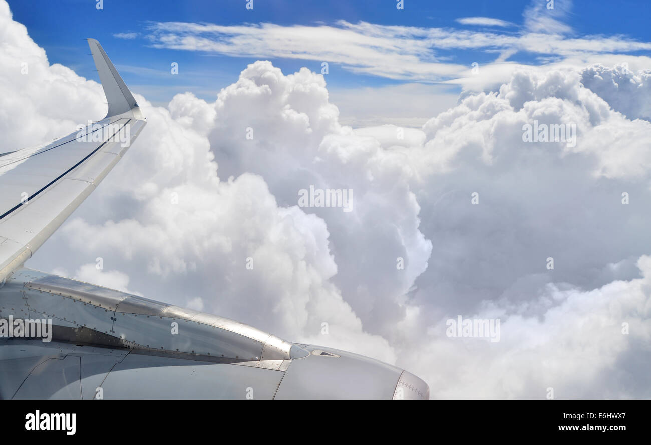 Airplane wing and engine flying high in the clouds Stock Photo - Alamy