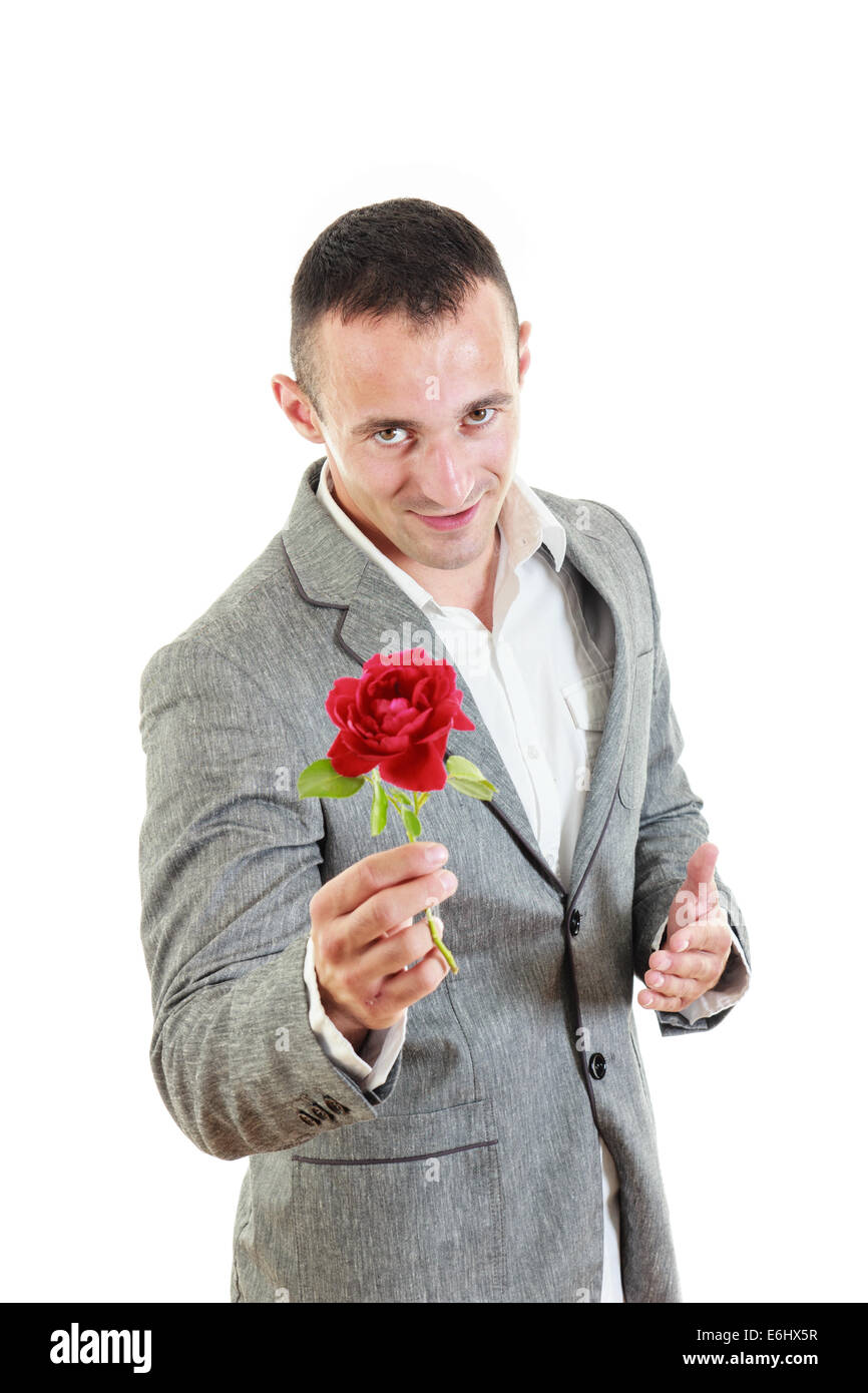 Young man in suit offering you a rose Stock Photo - Alamy
