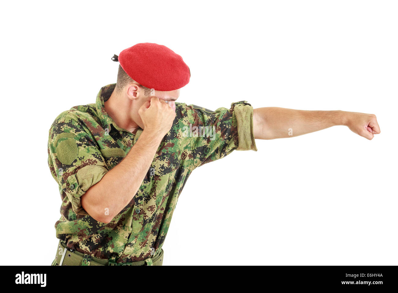 Soldier in military uniform and cap hitting with fist in defence Stock ...