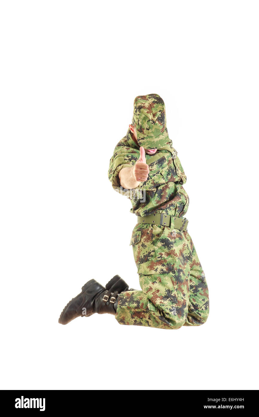 unknown soldier with hidden face in green camouflage uniform and hat ...