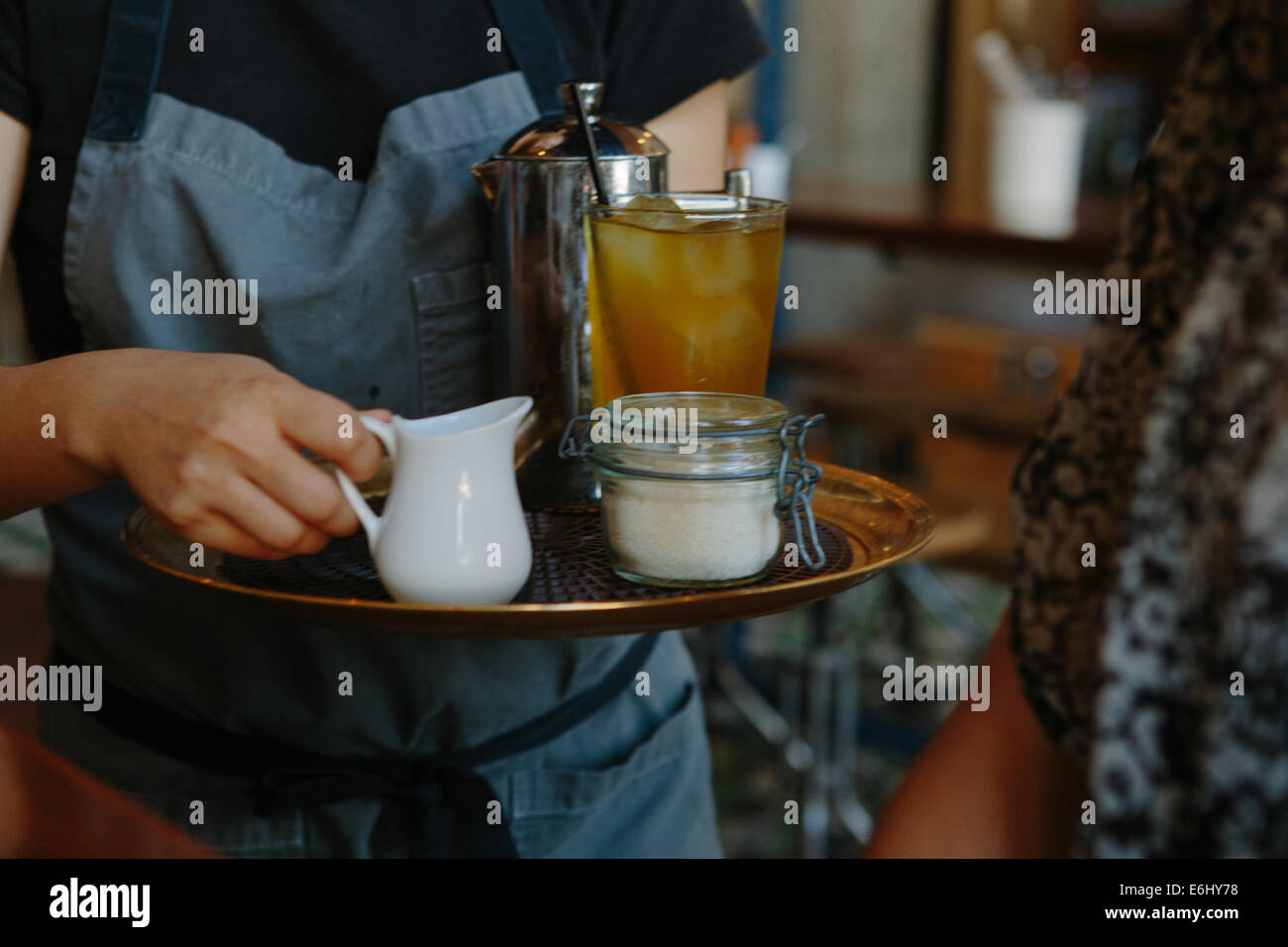 Server with coffee, milk, iced tea, and sugar on a platter Stock Photo ...