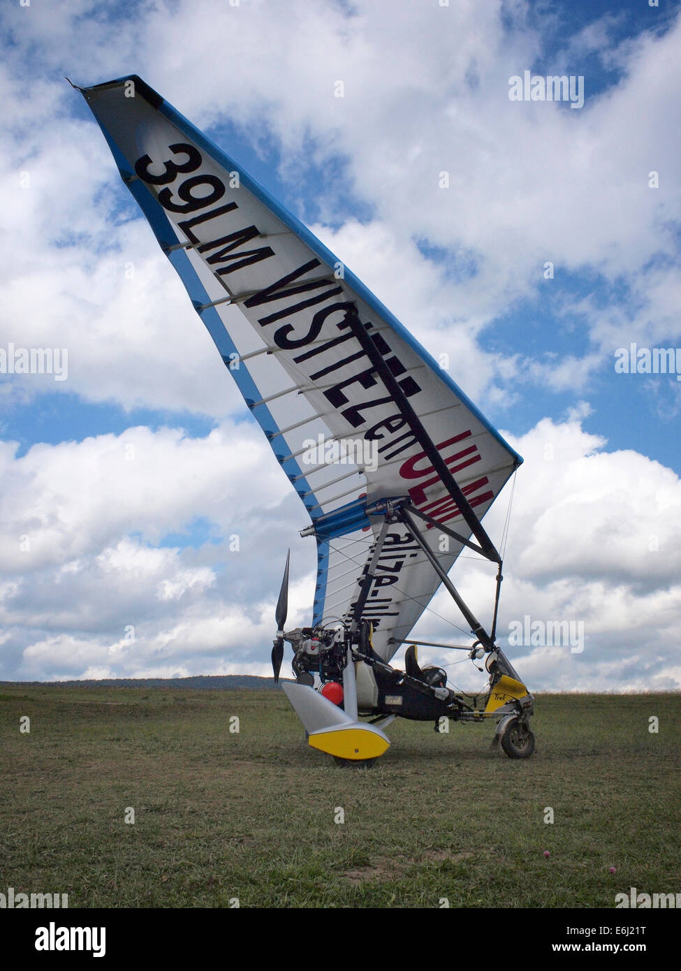 Ultralight aeroplane on the ground, with blue sky with clouds, Jura ...