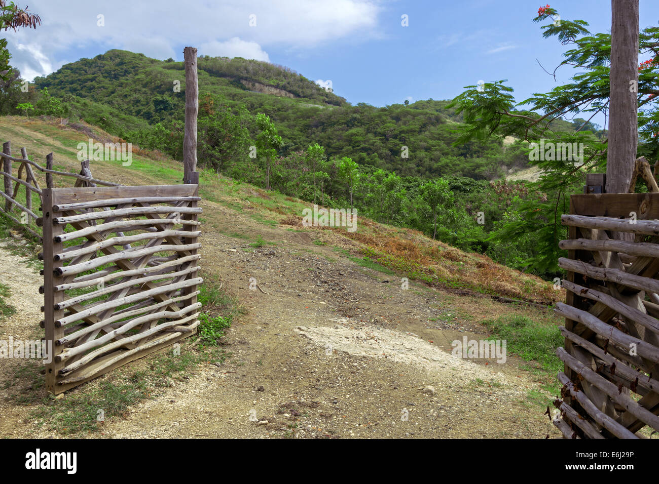 Open gate and road, hill landscape as background Stock Photo - Alamy