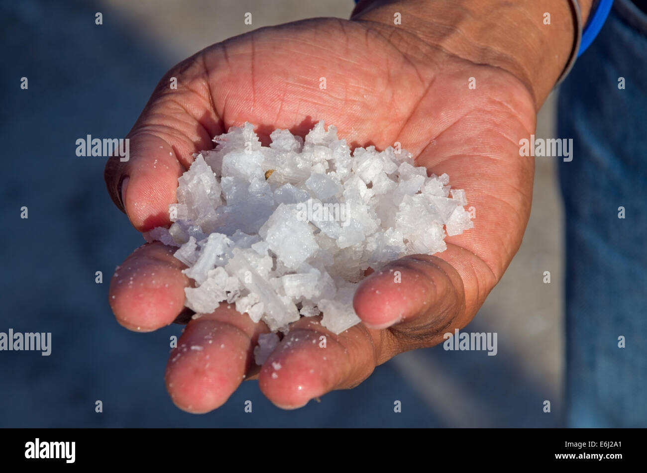 Handful of white salt crystal in rough palm Stock Photo - Alamy