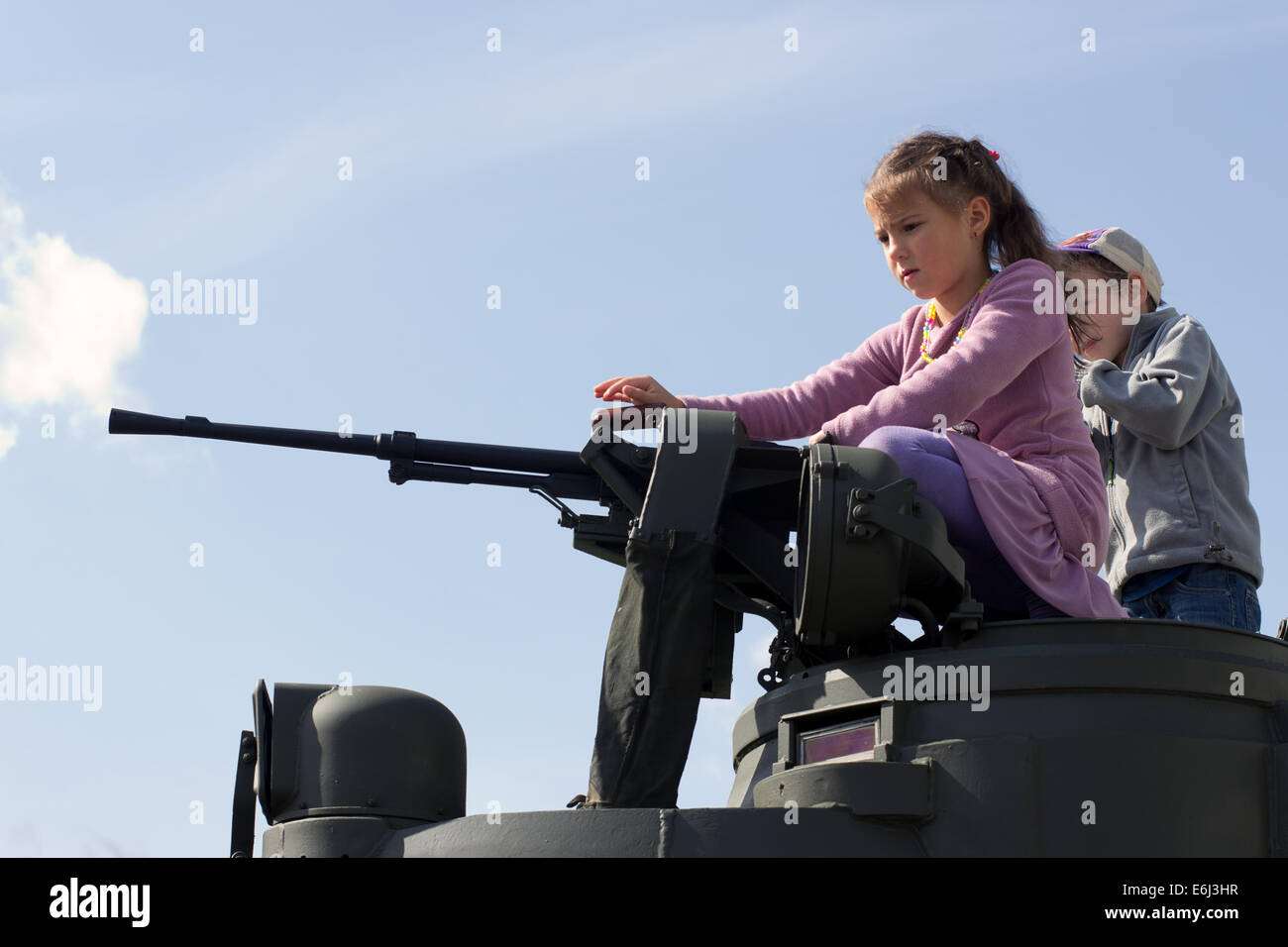 Children are playing with military technics during the exhibition of ...