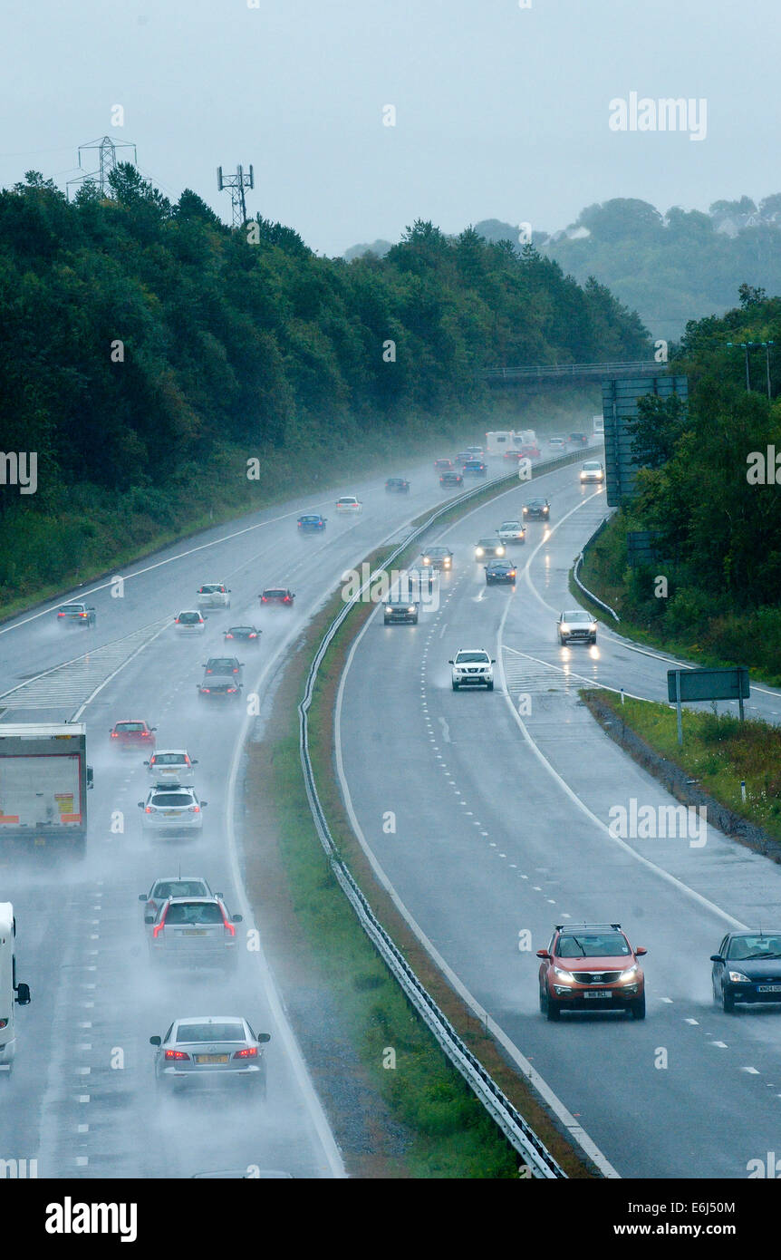 Swansea, UK. 25th August 2014. People return home in the rain along the ...