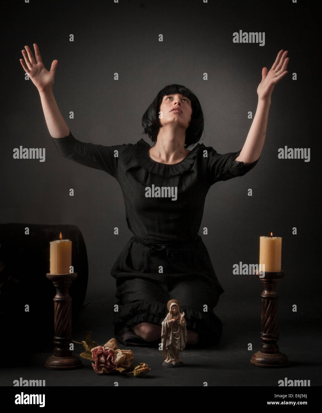 woman dressed in mourning beseeching God with arms raised Stock Photo ...