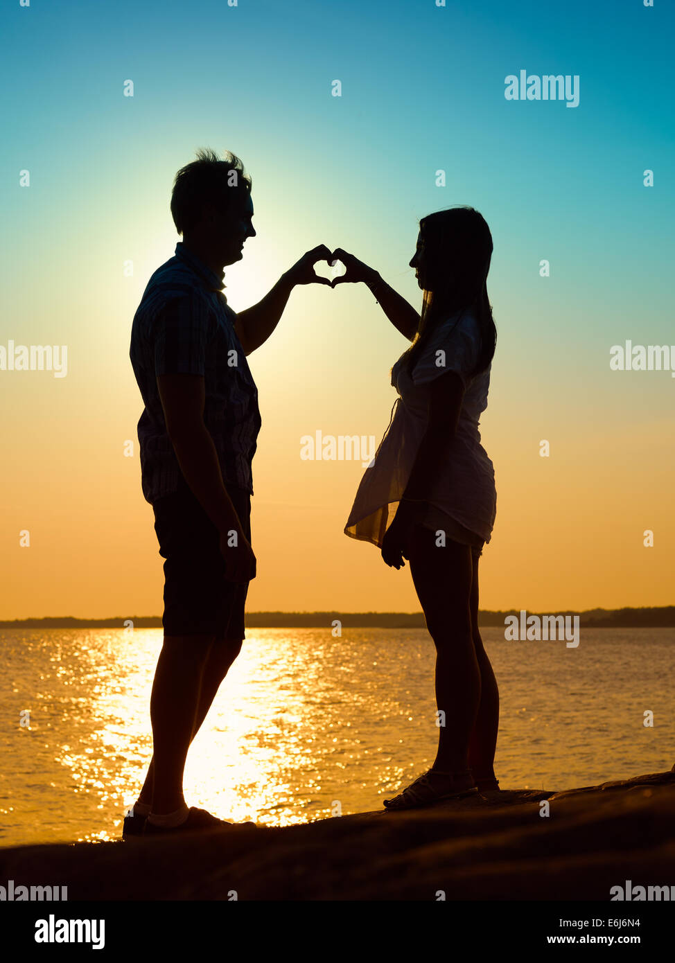 In love young couple enjoying the sunset together, beautiful evening in ...