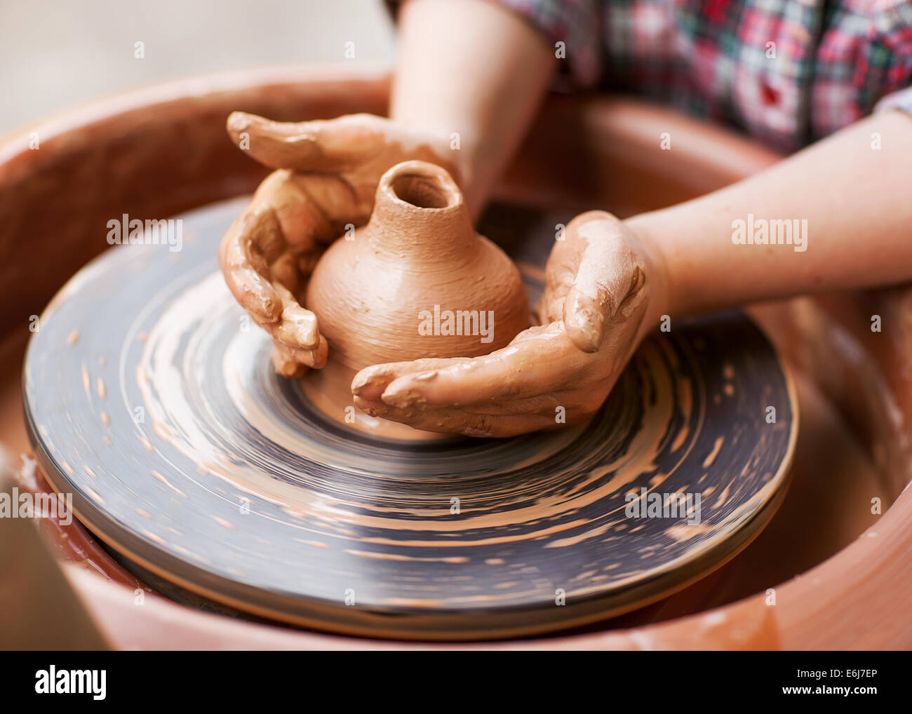 Hands working on pottery wheel Stock Photo - Alamy