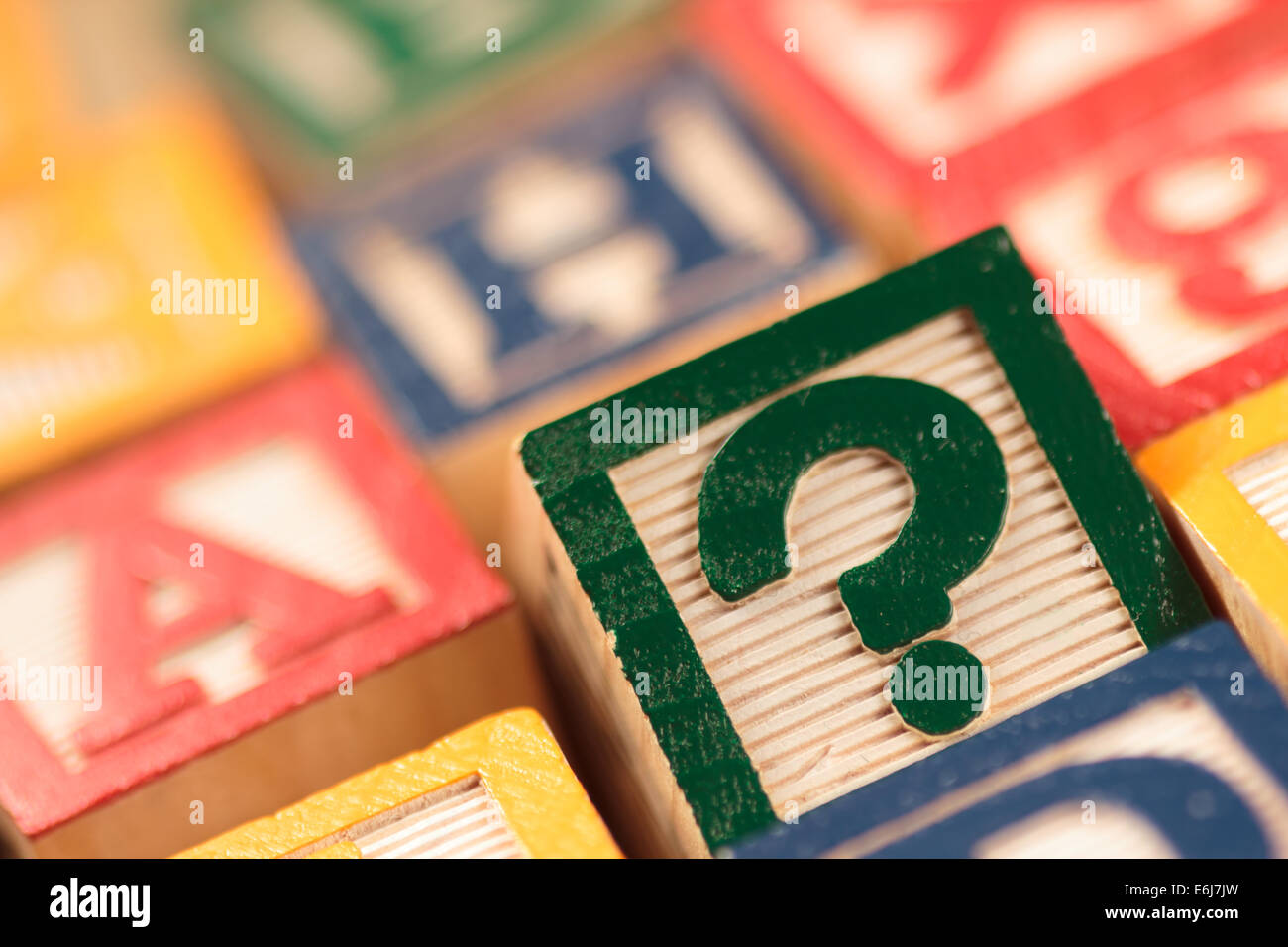 Wooden, colorful educational blocks with selective focus on question ...