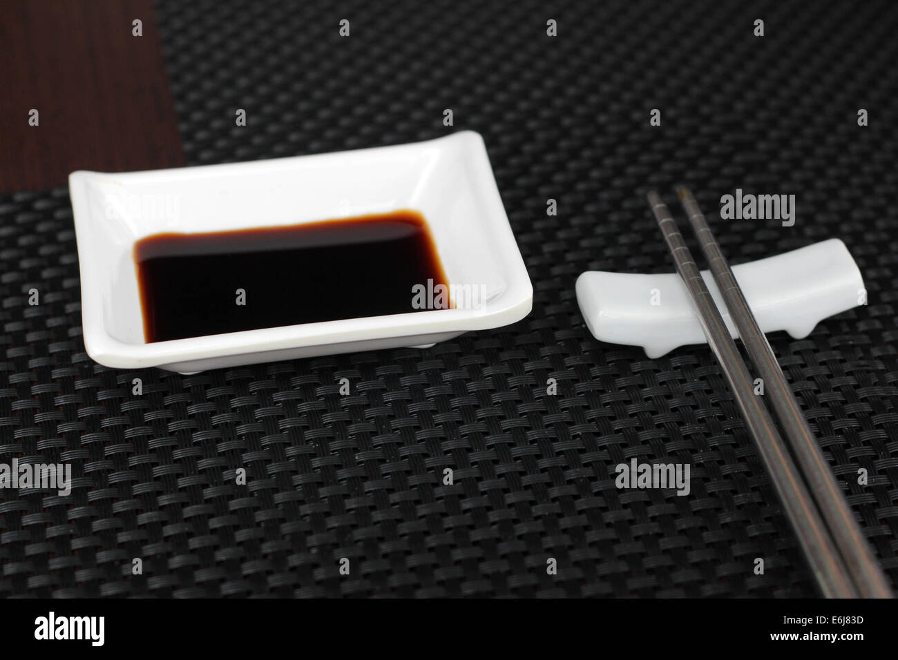 Soy sauce in a square small plate Stock Photo - Alamy