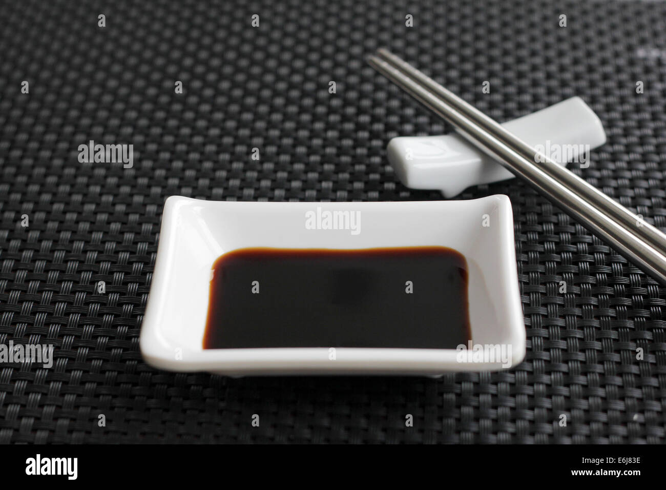 Soy sauce in a square small plate Stock Photo - Alamy
