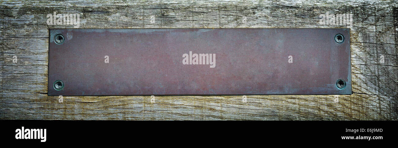 Rustic metal plate on wooden background Stock Photo - Alamy