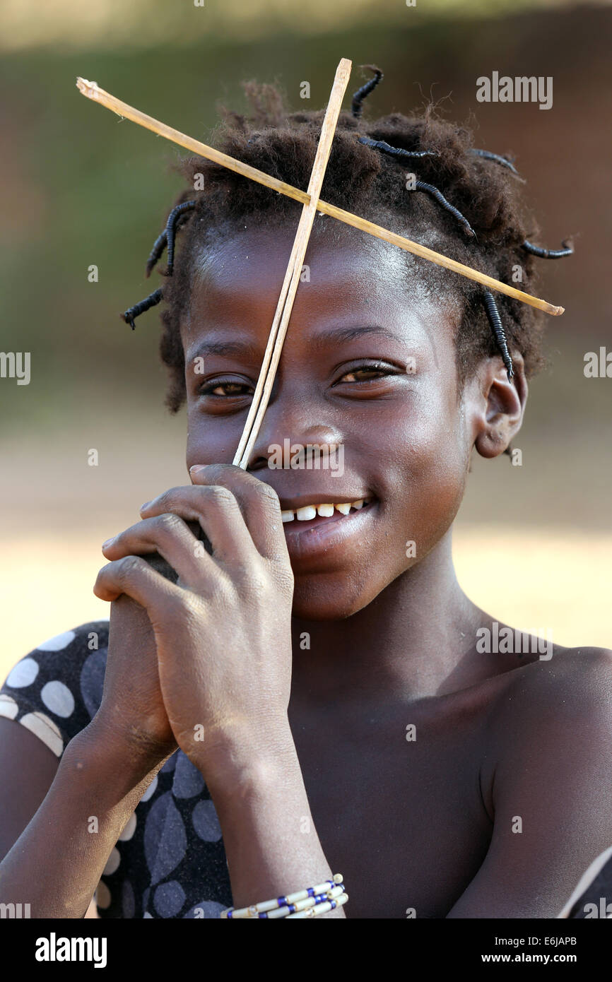 Girl with across from stalks, blades. Burkina Faso, Africa Stock Photo ...
