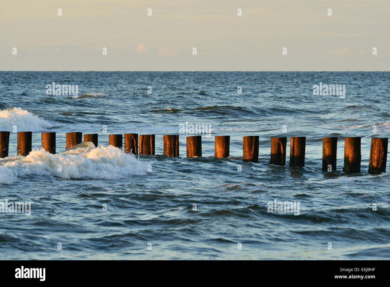 Row of wooden piles in moved water of the North Sea, 18 August 2013 ...