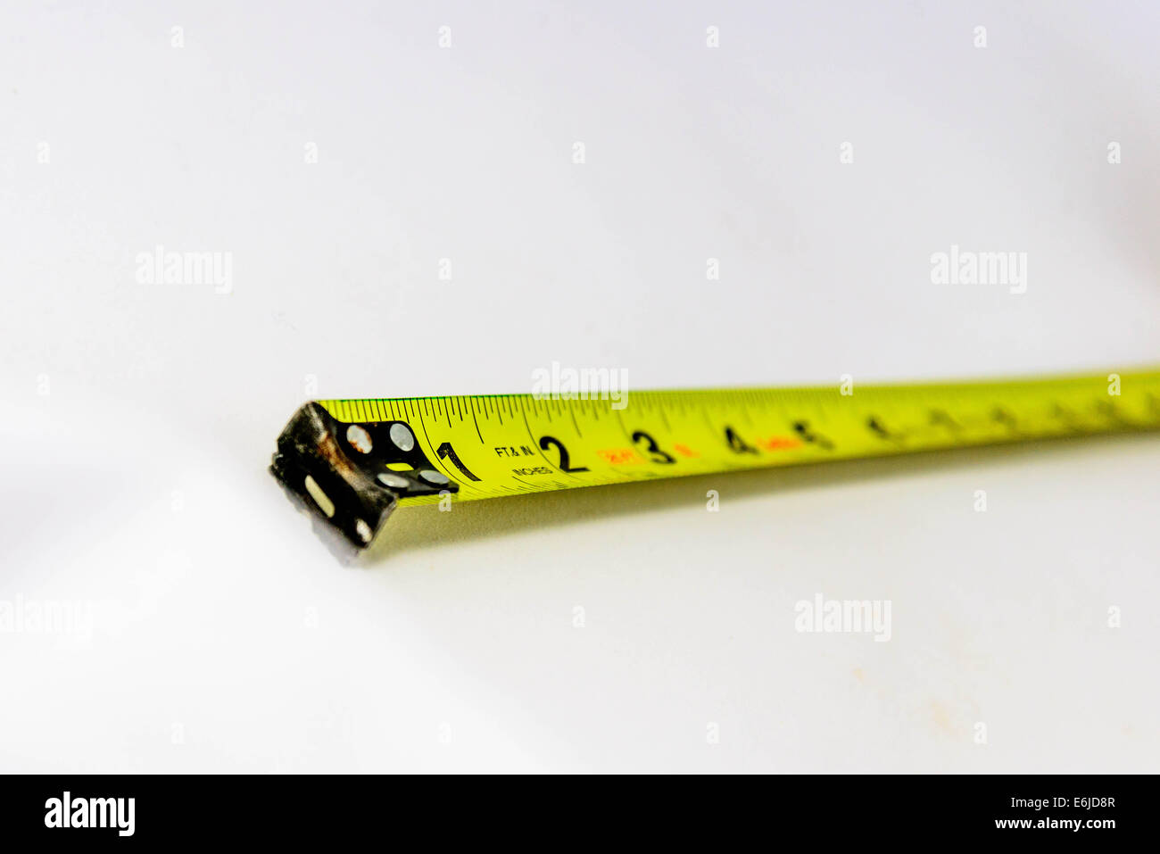 a yellow extended tape measure Stock Photo - Alamy