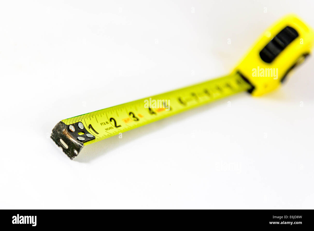 a yellow extended tape measure Stock Photo - Alamy