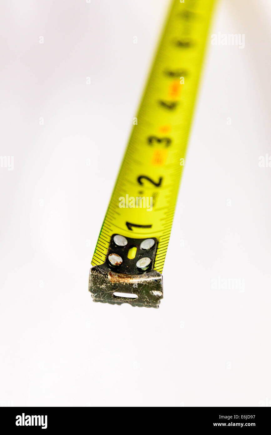 a yellow extended tape measure Stock Photo - Alamy