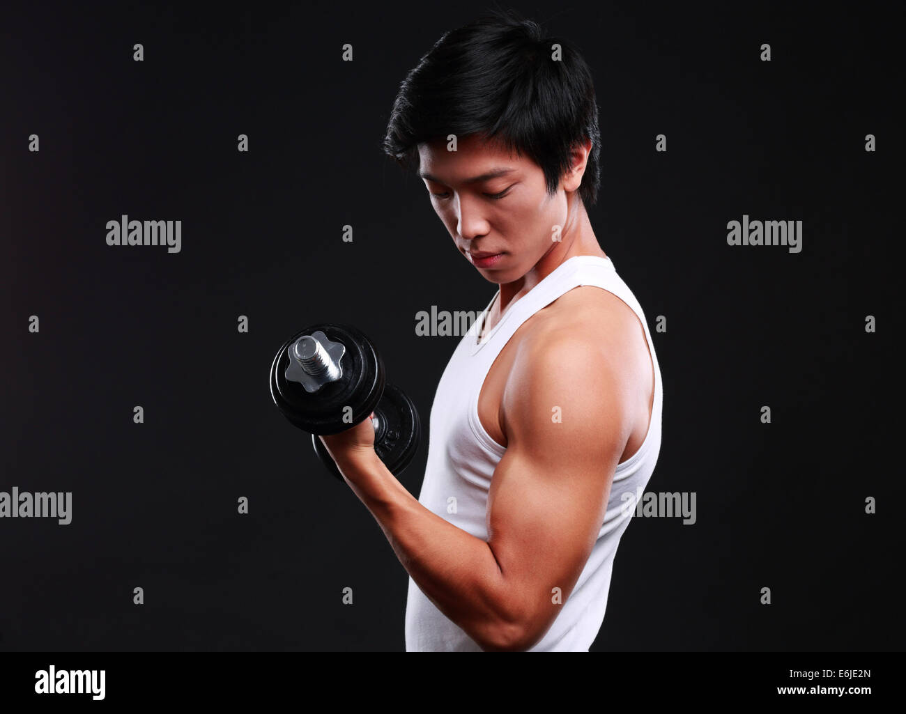 Asian man working out with dumbbells on black background Stock Photo ...