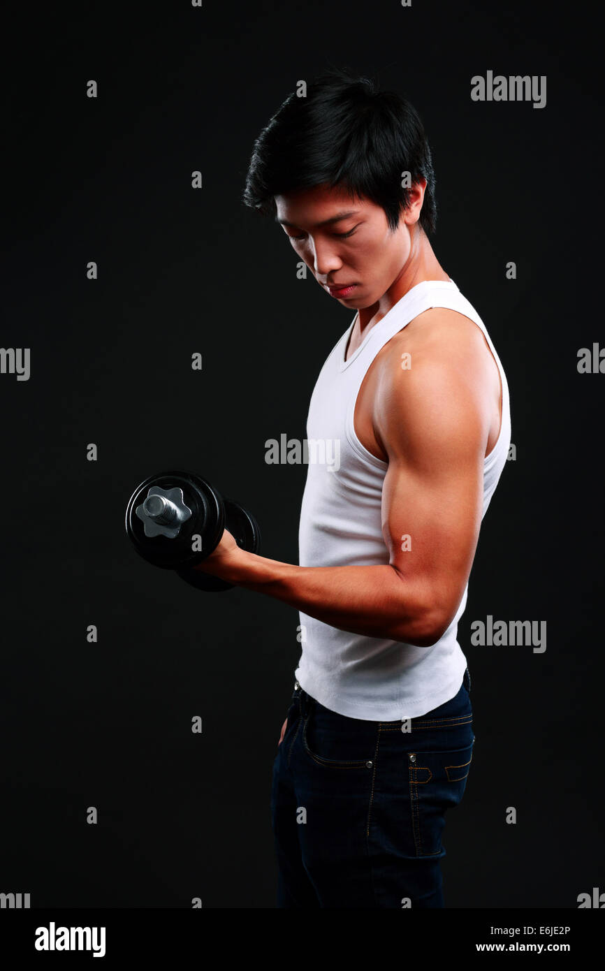 Asian man working out with dumbbells on black background Stock Photo ...
