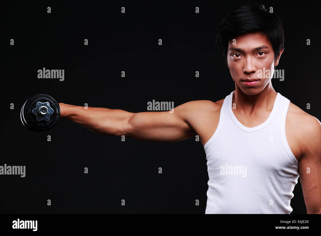 Chinese man working out with dumbbell on black background Stock Photo ...