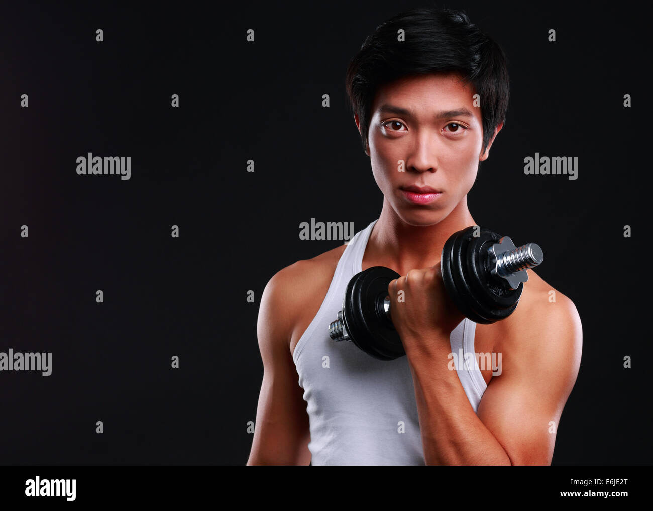 Chinese man working out with dumbbell on black background Stock Photo ...