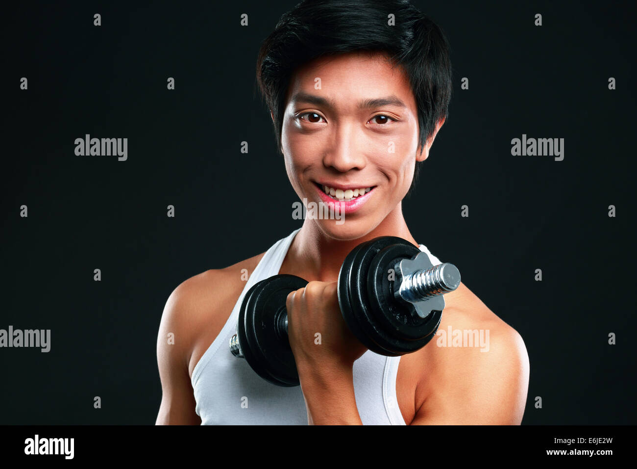 Happy asian man working out with dumbbells on black backgroung Stock ...