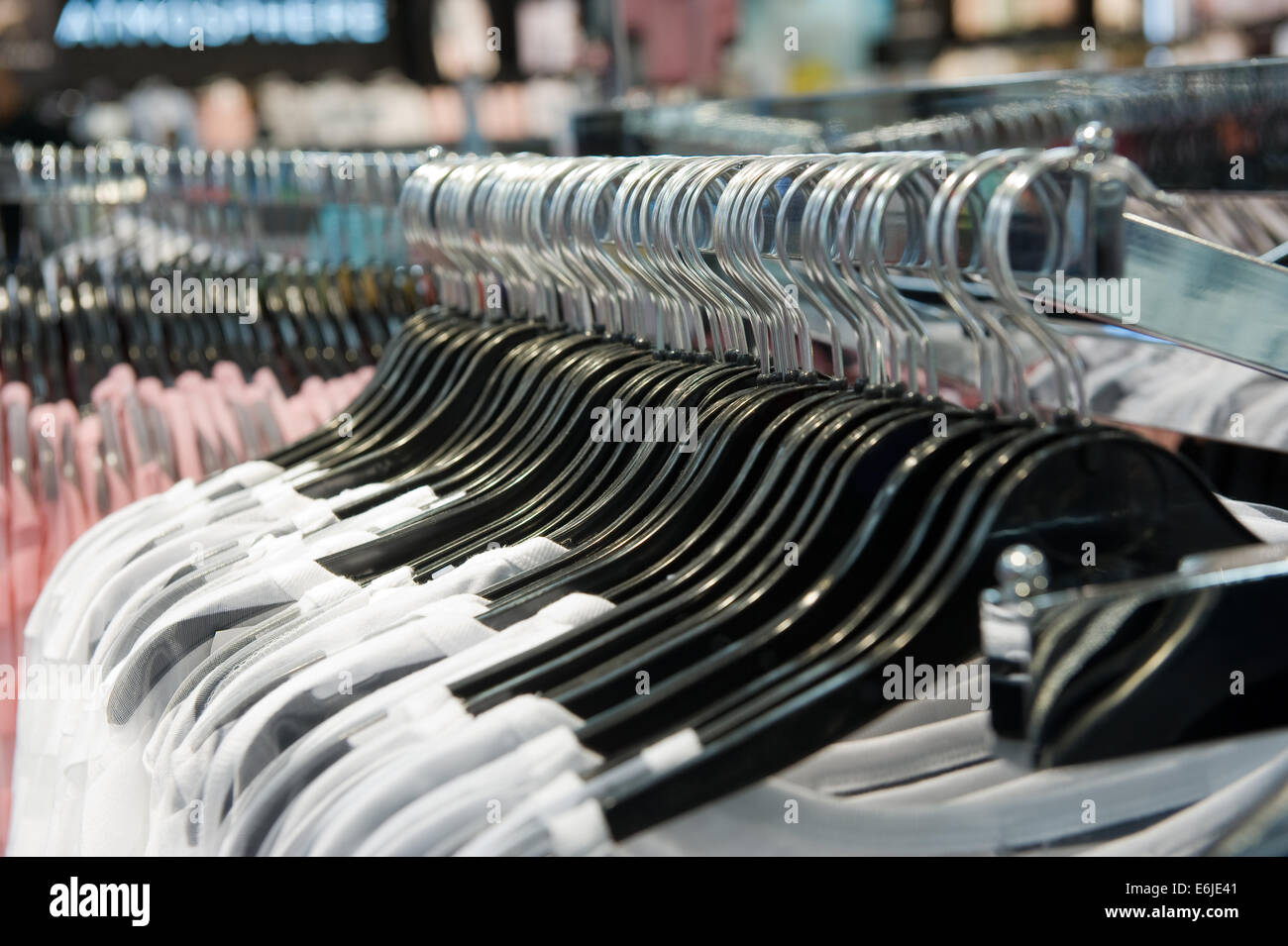 Clothes hangers with clothes in a shop Stock Photo - Alamy