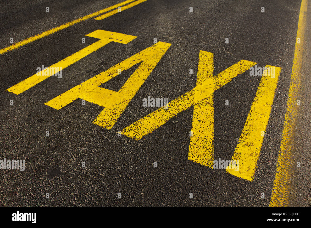 yellow taxi sign painted on the street Stock Photo - Alamy