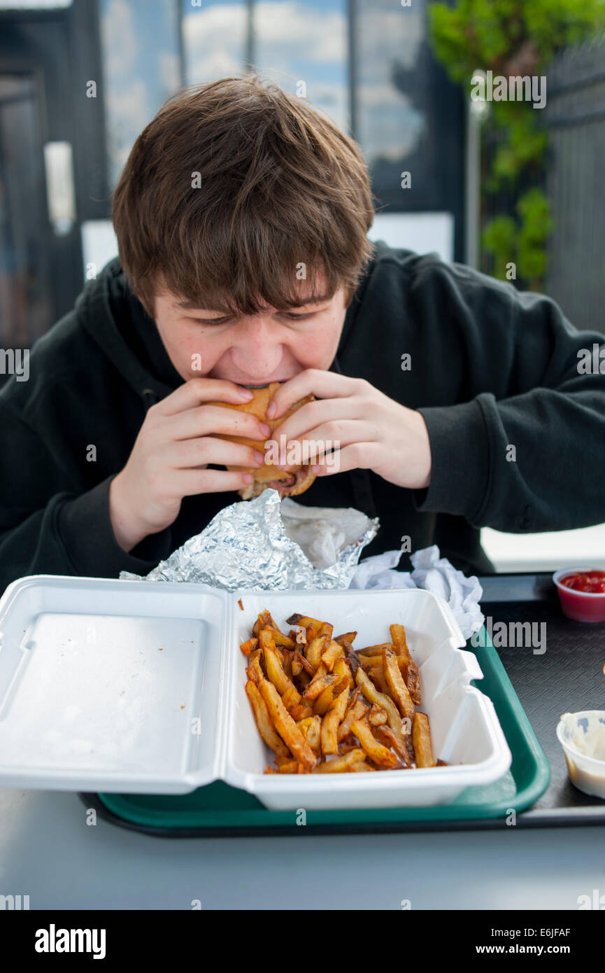 Boy teenager eating fries unhealthy hi-res stock photography and images ...