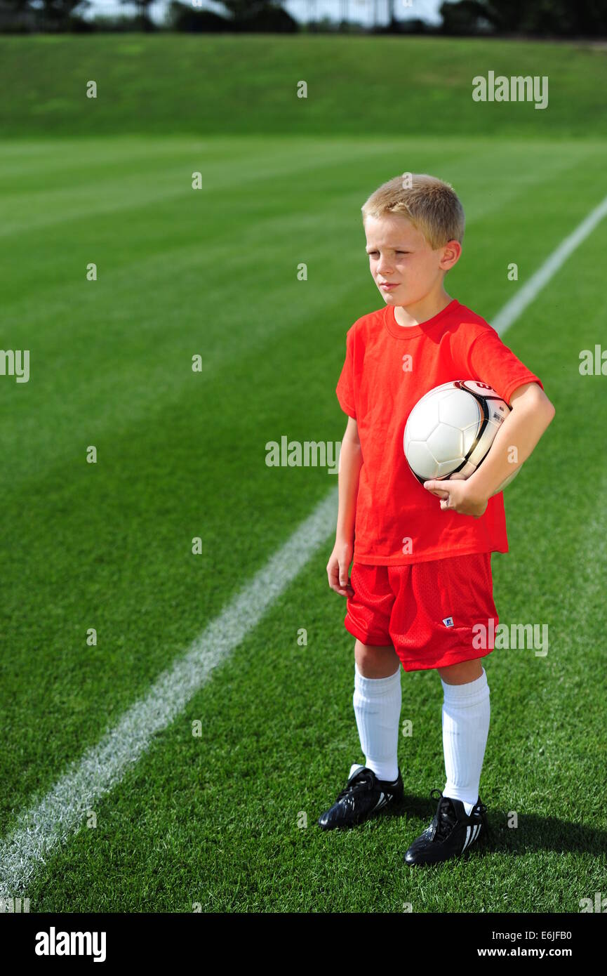 Boy 9 10 11 playing football futbol soccer on grassy pitch field not ...