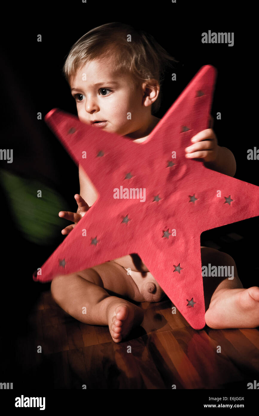 little boy sitting with Christmas star Stock Photo - Alamy