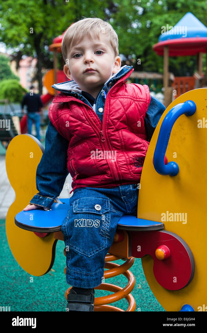 child to the playground on a spring horse Stock Photo - Alamy