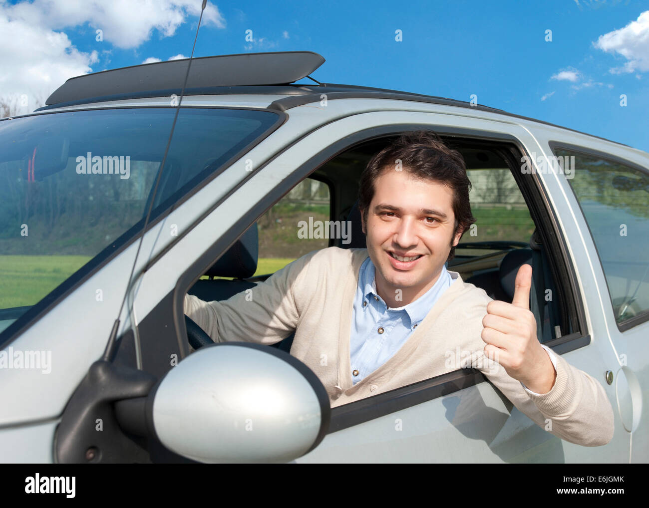 Relaxed driver smiling on his car Stock Photo - Alamy