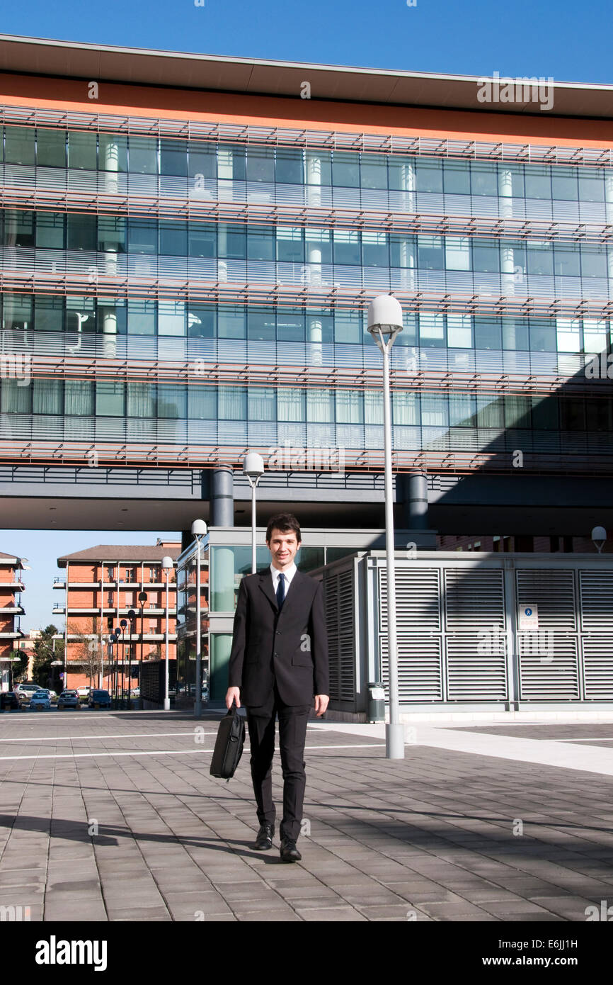 Young manager walking outside his office Stock Photo - Alamy