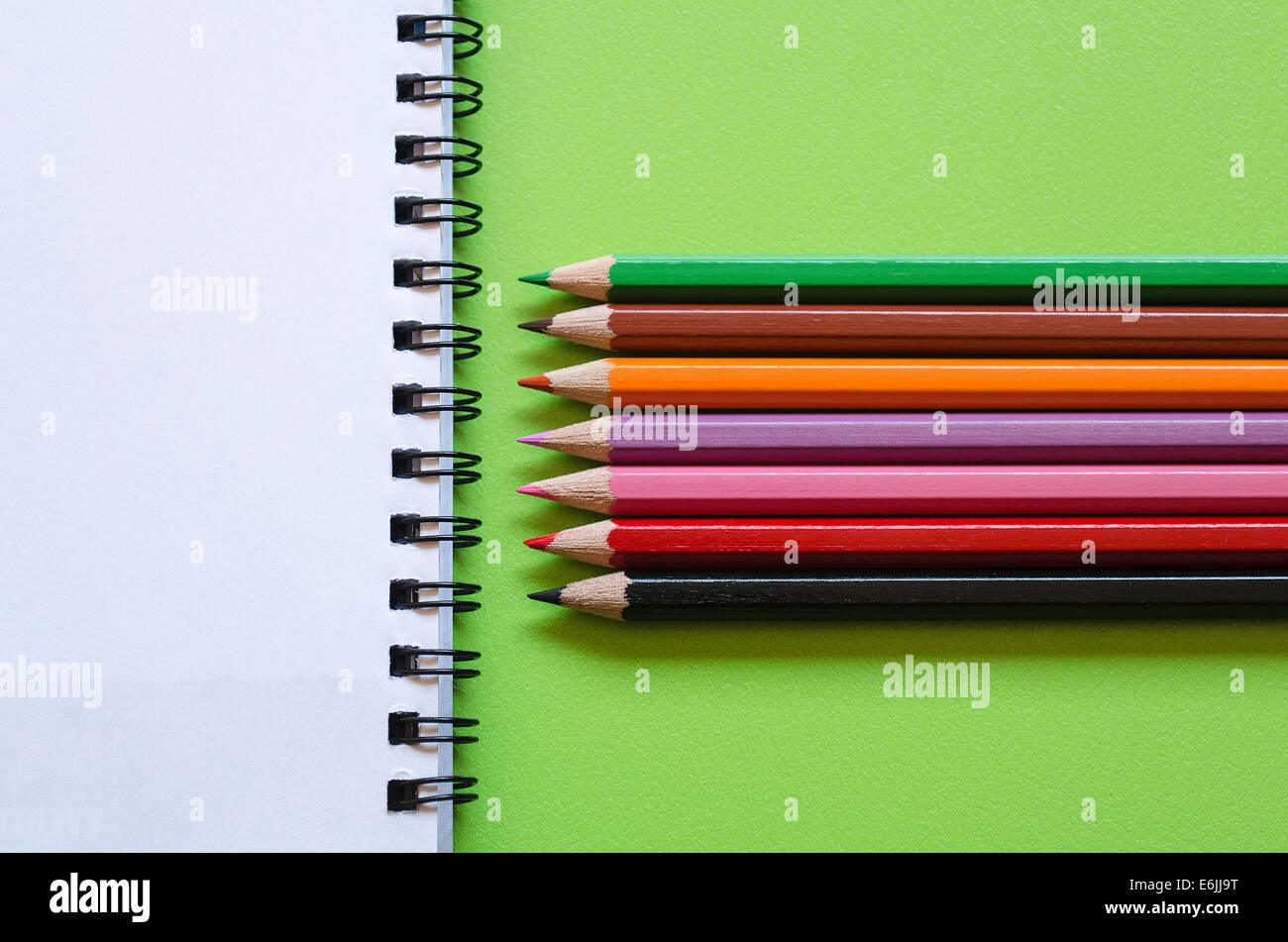 Colorful pencil crayons on a green background, back to school Stock ...