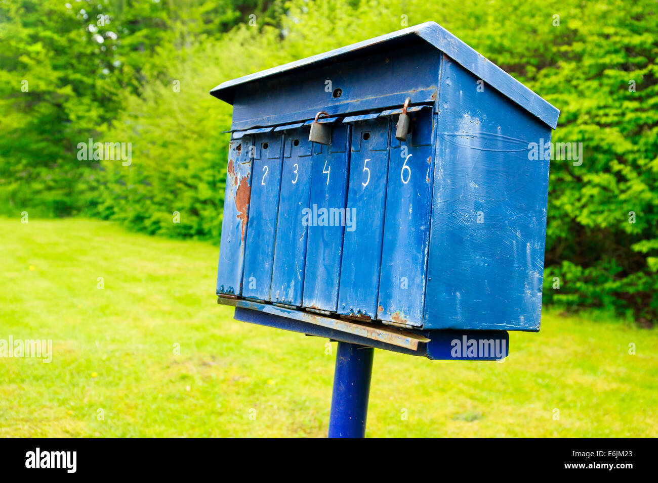 Old blue mailbox on a stake somewhere in the country Stock Photo - Alamy