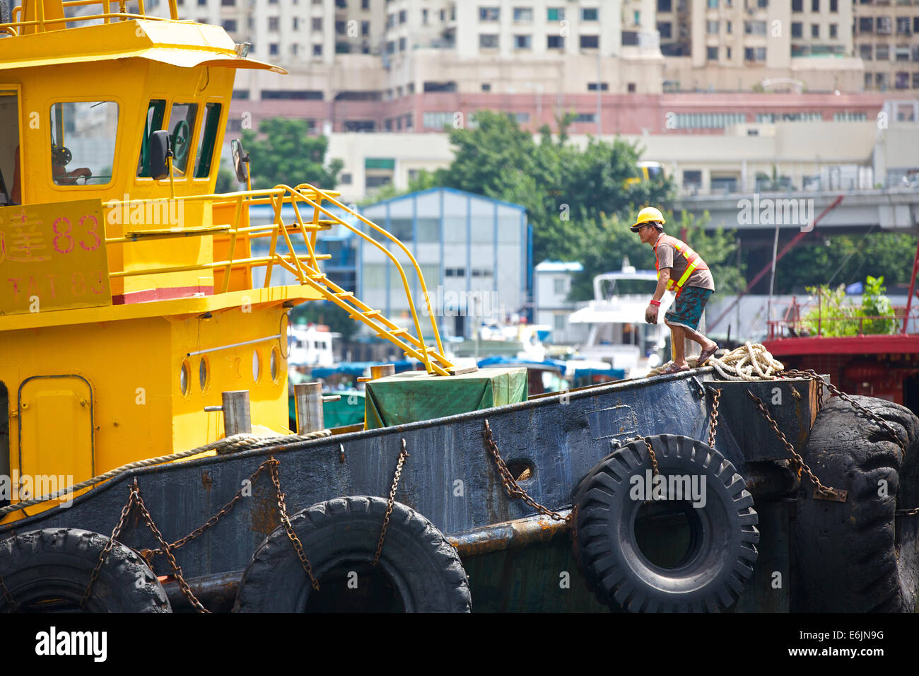 Deckhand Arranging Ropes On A Tug In The Causeway Bay Typhoon Shelter ...